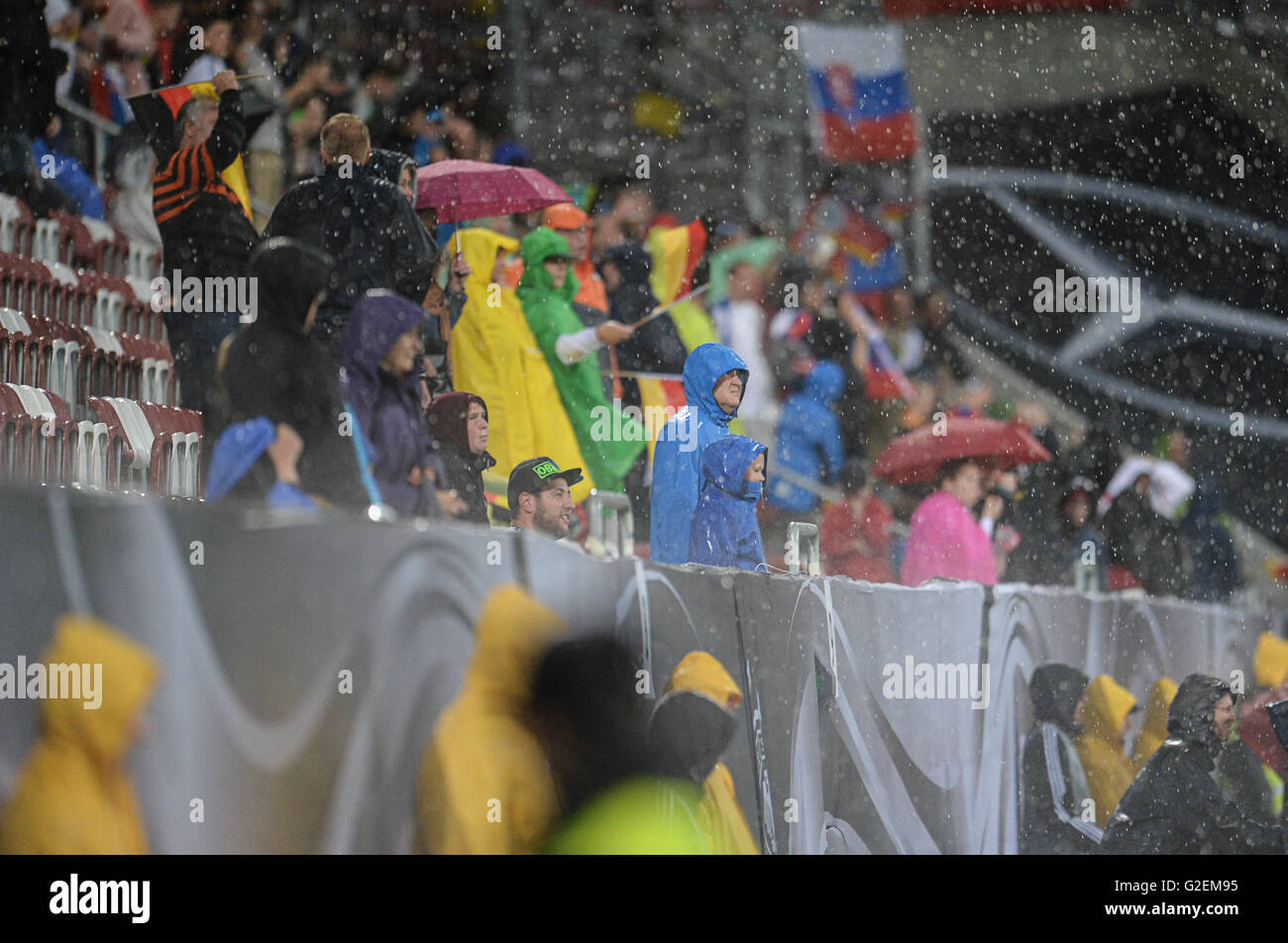 German soccer fans stand in the rain in the stands during the ...