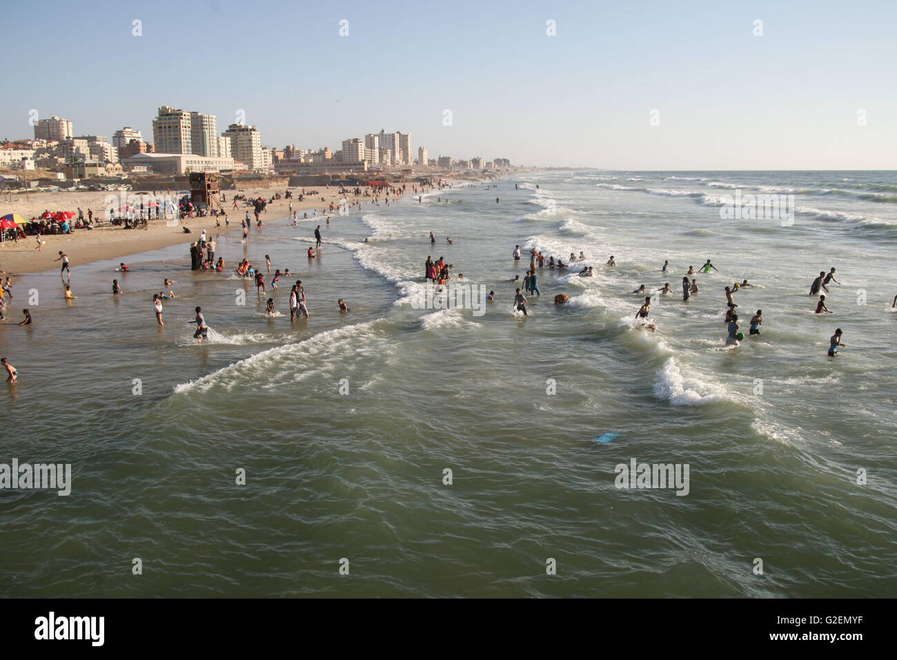 Palestinians swim in the Mediterranean Sea at a beach in Gaza City ...