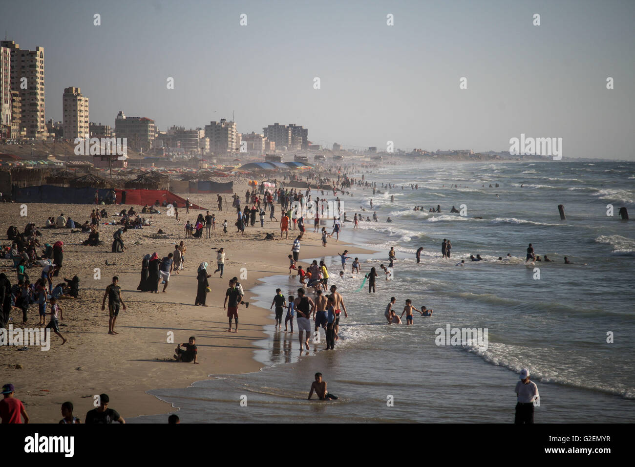 Palestinians swim in the Mediterranean Sea at a beach in Gaza City ...