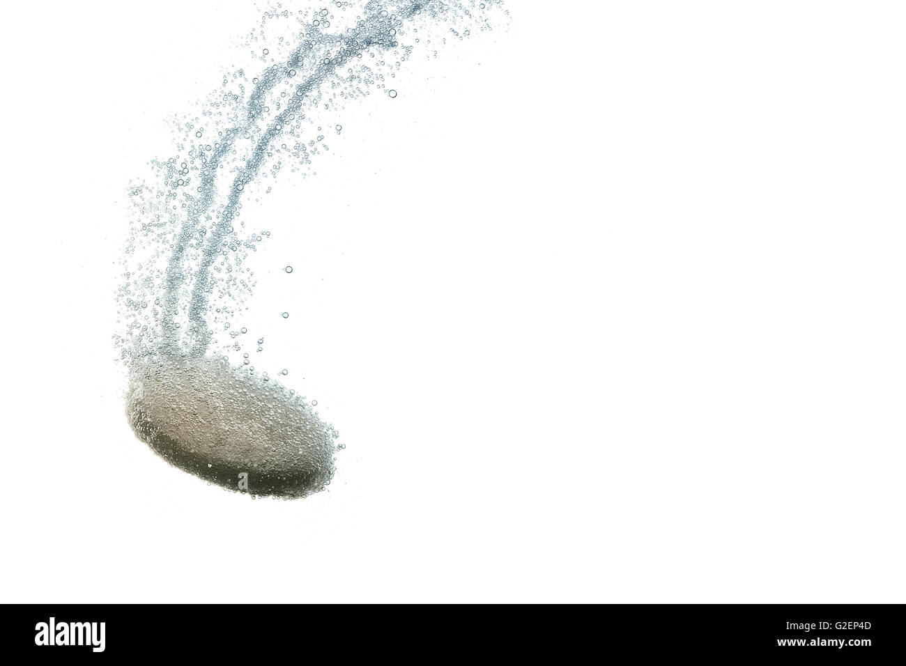 Effervescent tablet falling in water Stock Photo - Alamy