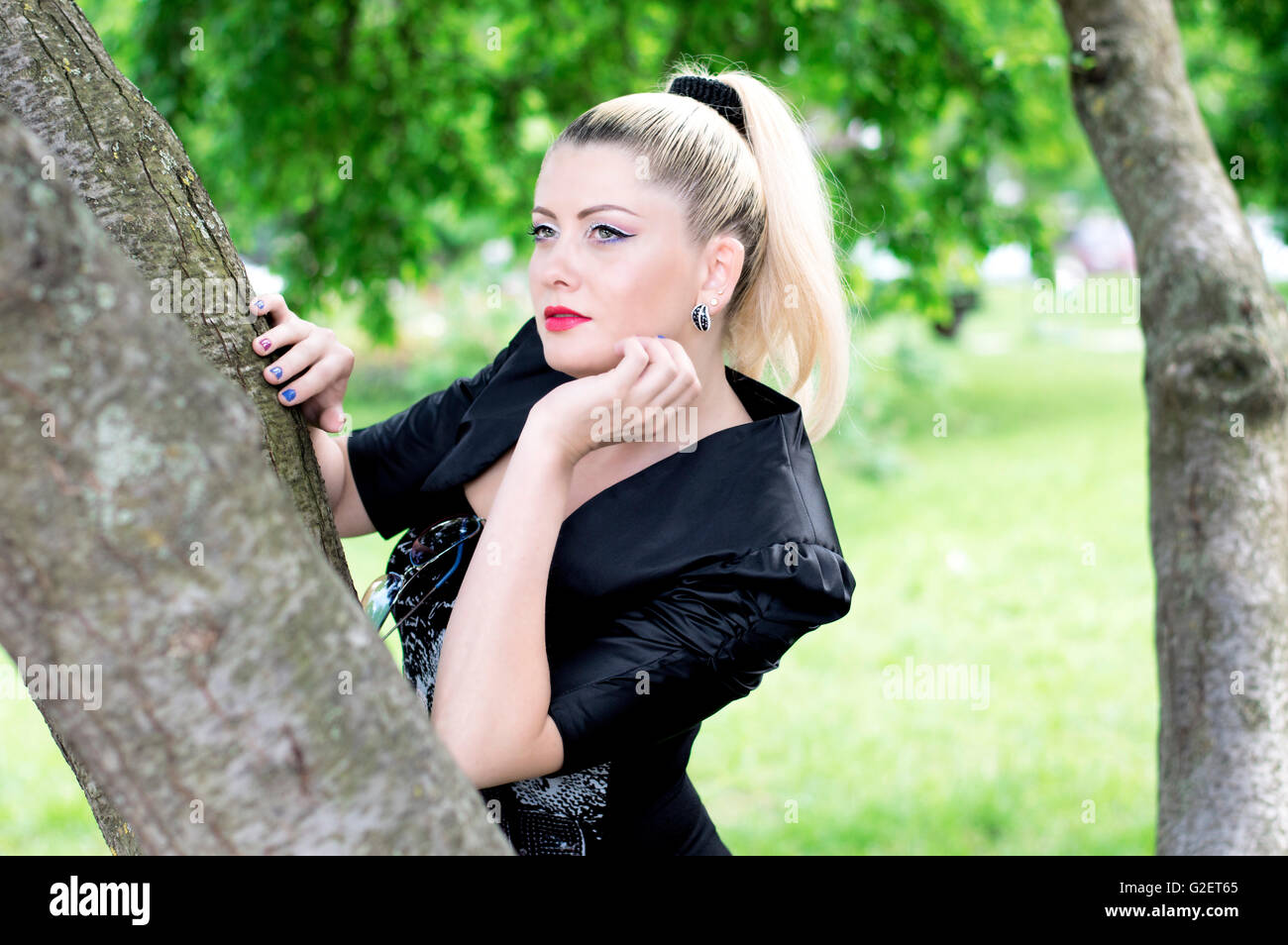 the beautiful woman in tree branches Stock Photo - Alamy