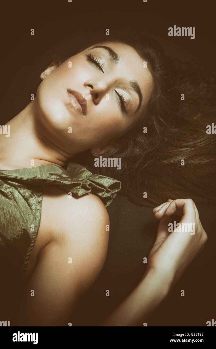 Beautiful young woman laying down eyes closed Stock Photo - Alamy