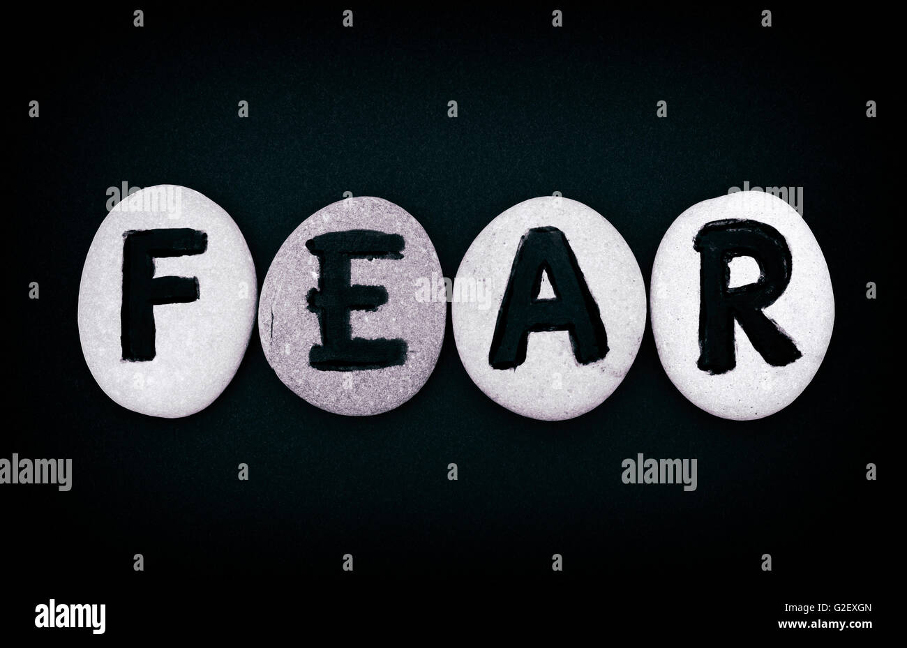 Word Fear spell out from stones with letters and black background ...