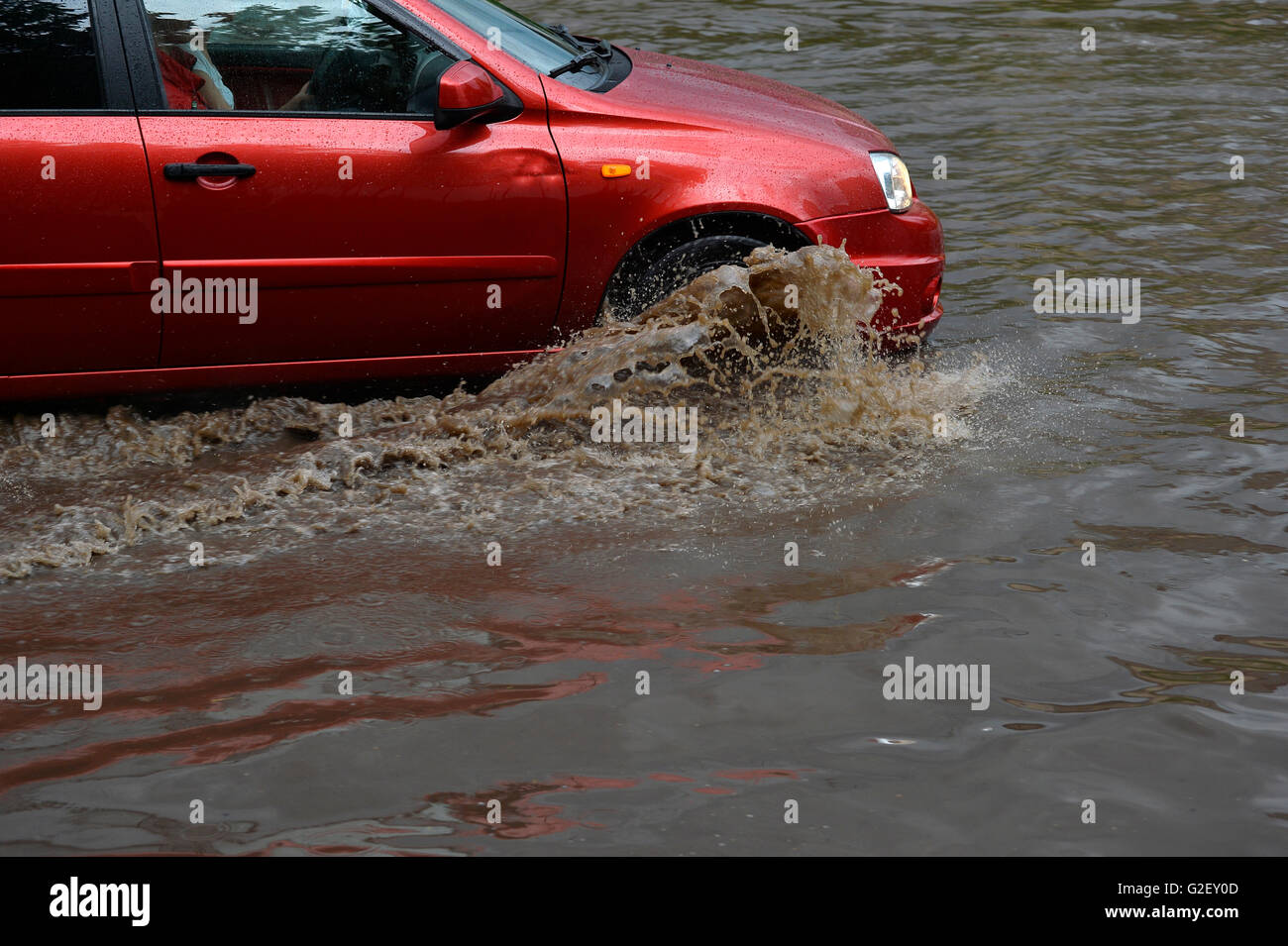 Car rides in heavy rain on a flooded road Stock Photo - Alamy