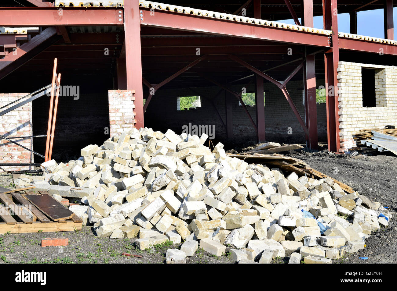 Construction materials and waste on the background of building under ...