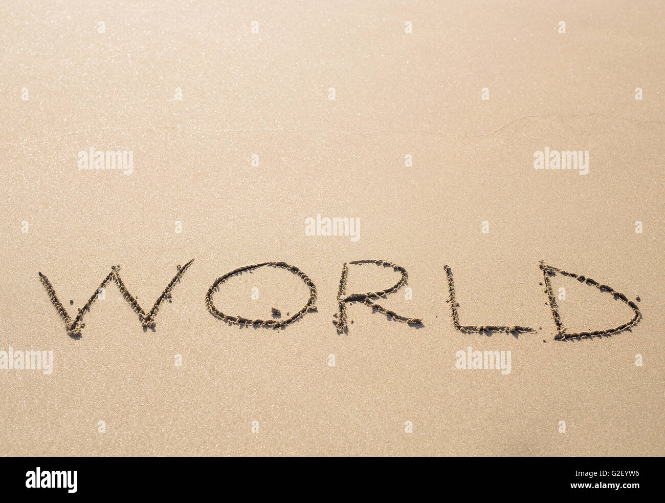 written word world on sand of beach Stock Photo - Alamy
