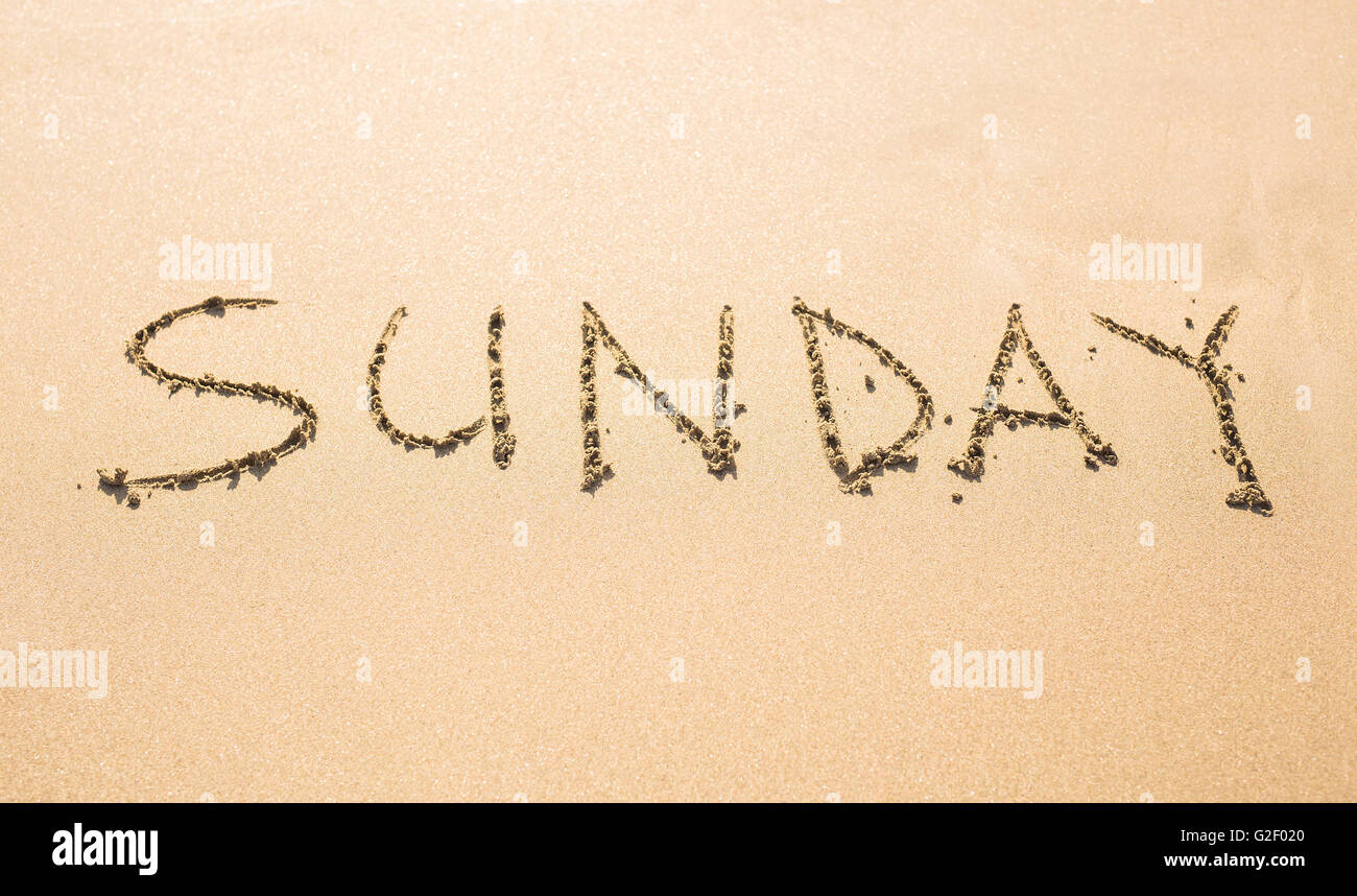 sunday written on a tropical beach Stock Photo - Alamy