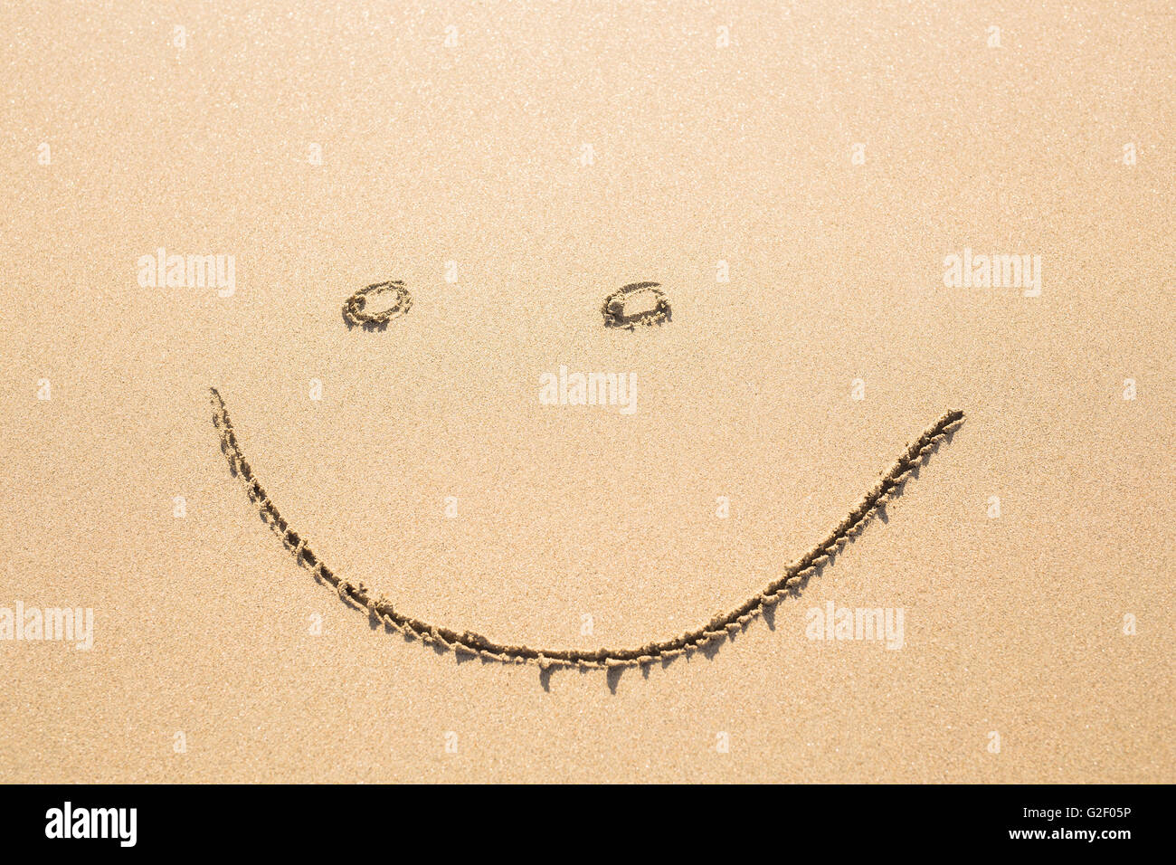 Symbol smile on beach background Stock Photo - Alamy