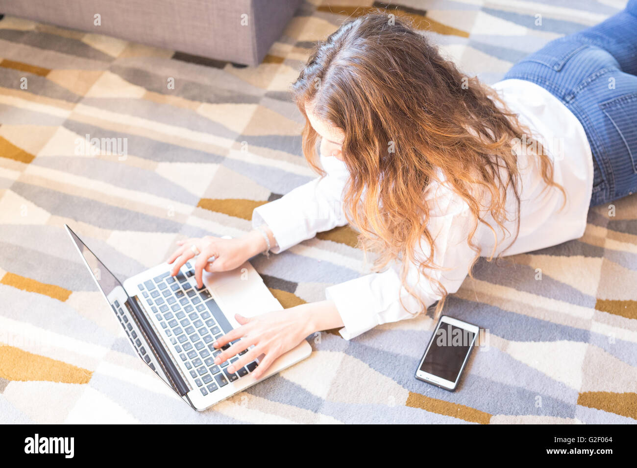 Beautiful woman relaxing with a computer Stock Photo - Alamy