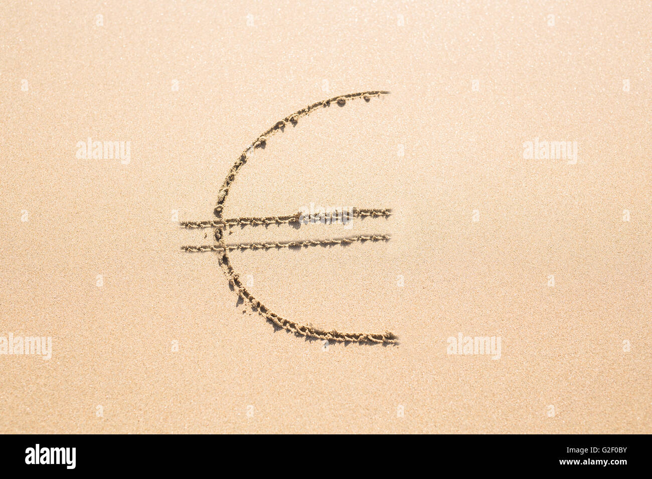 sign of the EURO currency drawn in the sand Stock Photo - Alamy