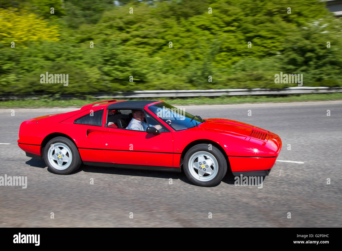 1985 80s red Ferrari 288 GTO, side view in motion; Pendle Power Fest, a ...