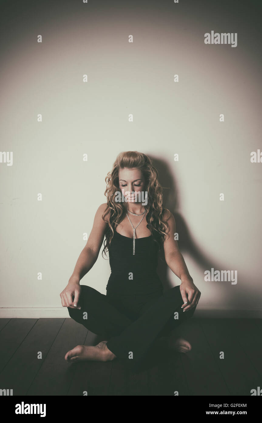 Young woman sat on the floor Stock Photo - Alamy