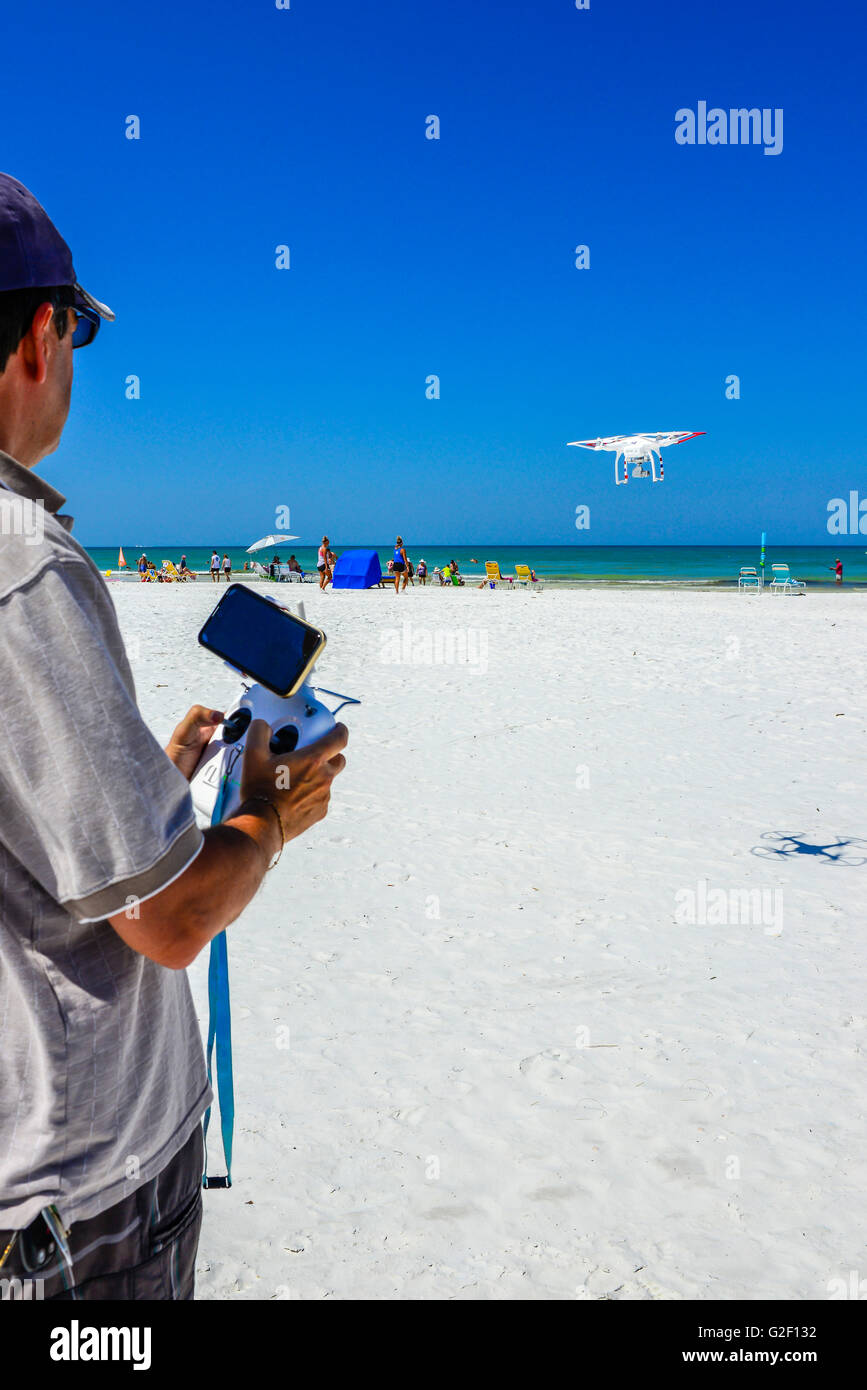 A drone pilot maneuvers the joy sticks on the radio controller for a ...