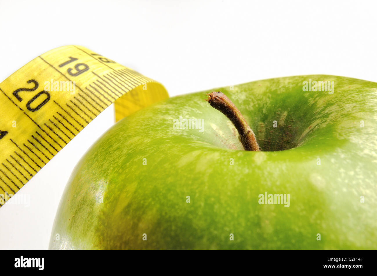 apple and measuring tape isolated for a healthy lifestyle Stock Photo ...