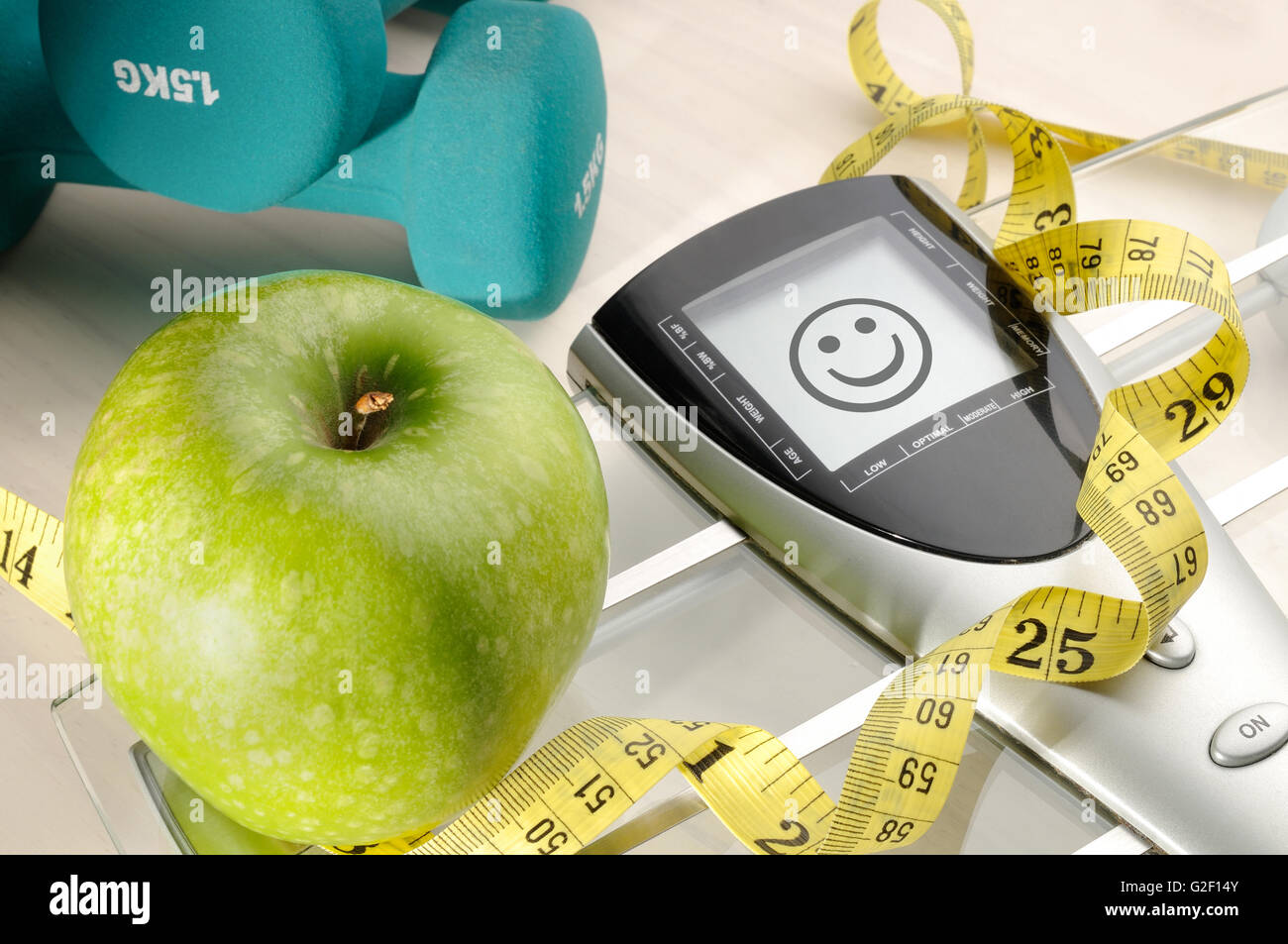 apple, scale and dumbbells for a healthy life and happy face message ...
