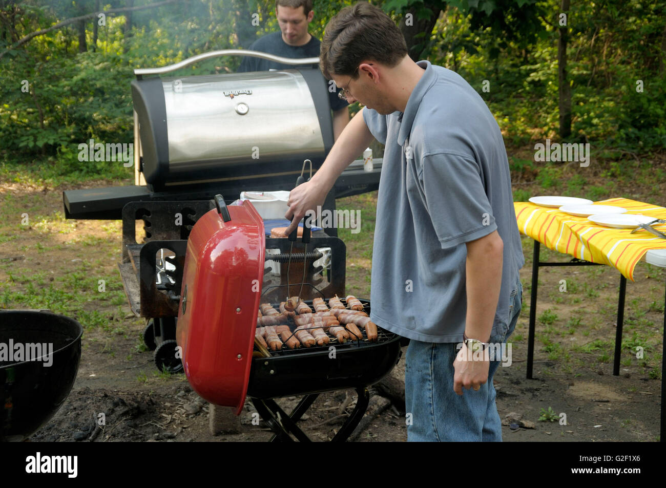 man grilling hot dogs at cookout in Greenbelt, Md Stock Photo - Alamy