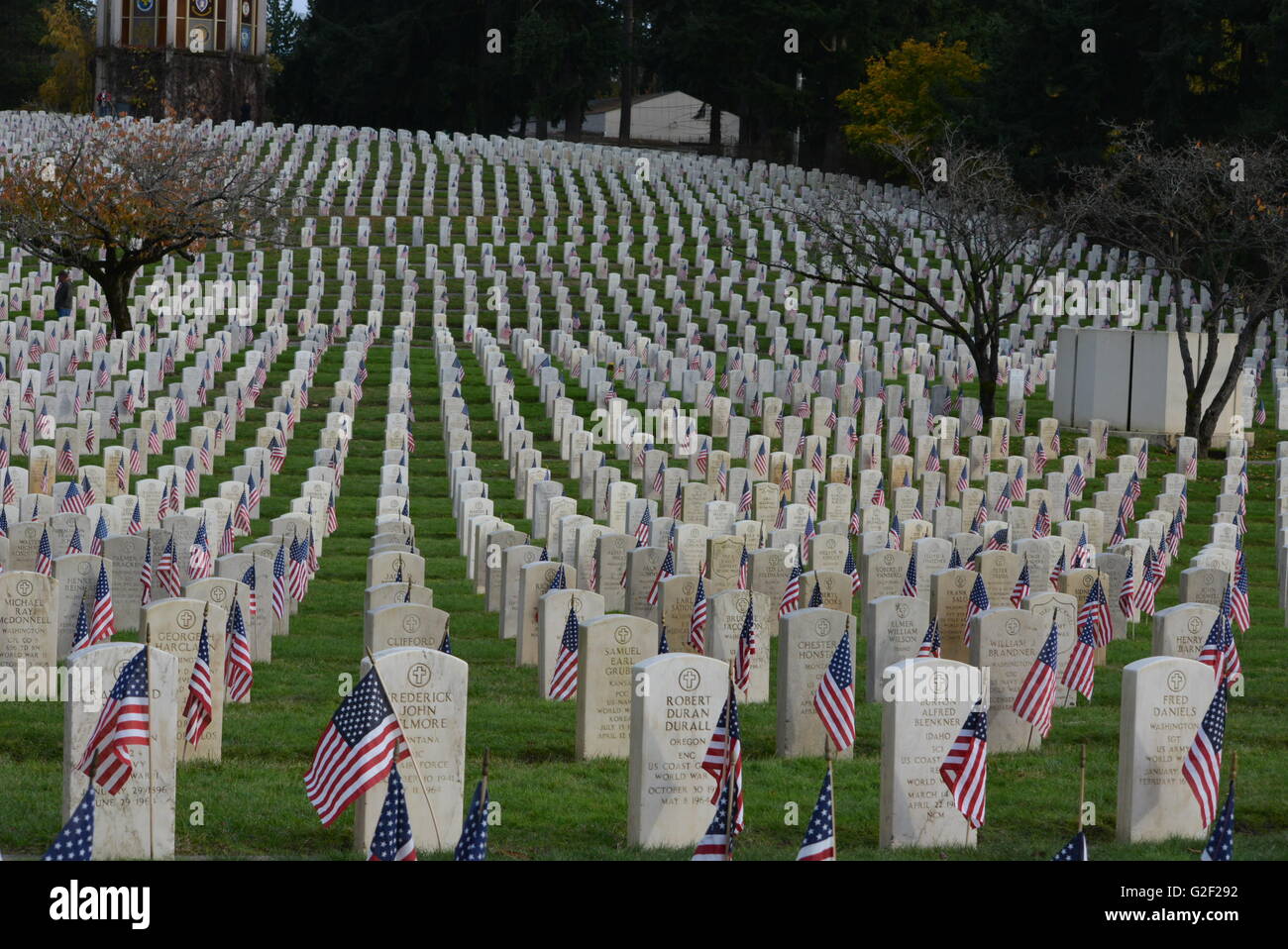 Flags decorate grave markers at Evergreen Washelli in Seattle as a ...