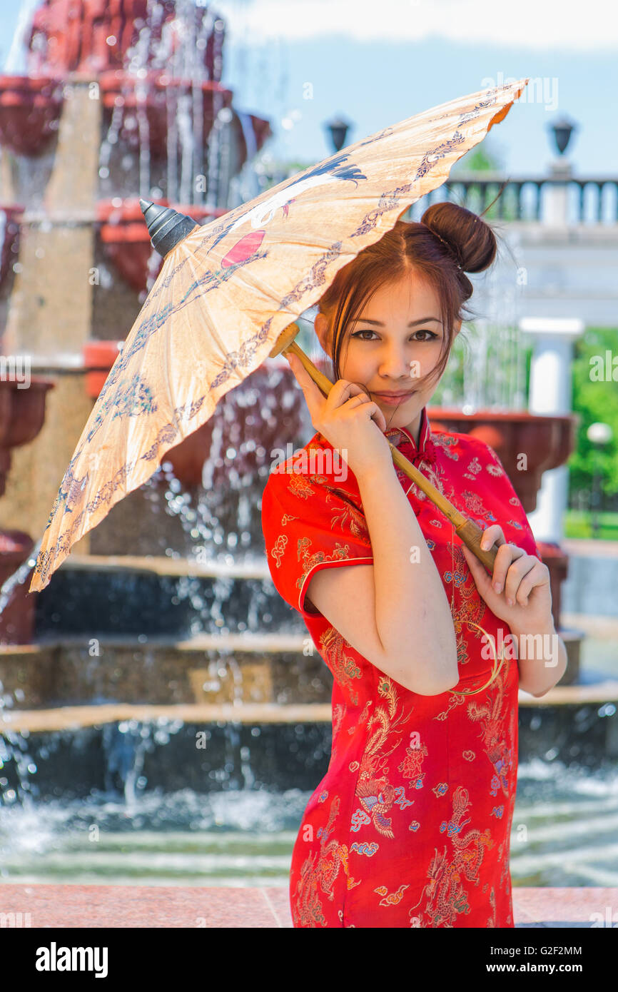 Beautiful asian girl in traditional chinese red dress with bamboo ...