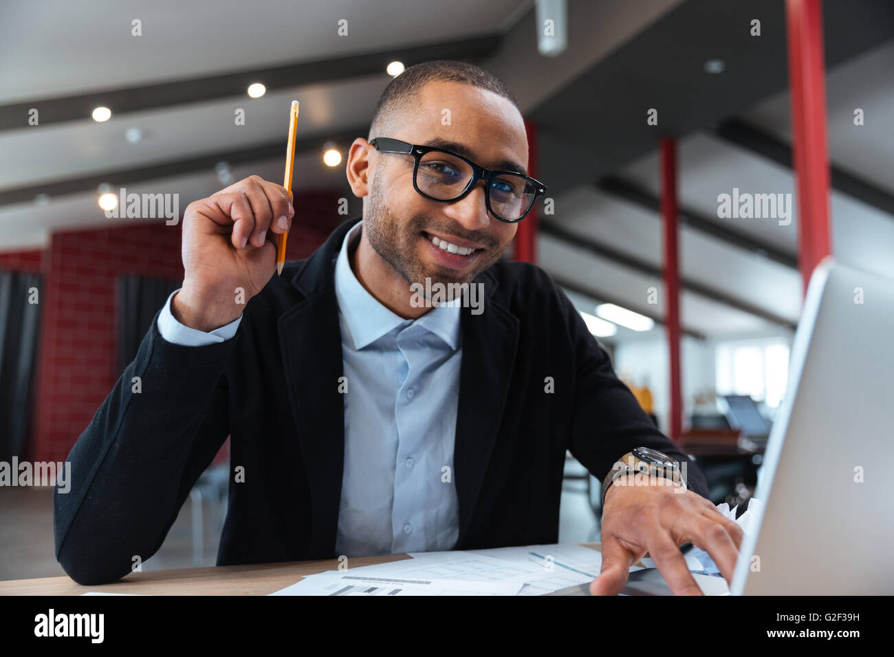 Clever businessman having a good idea holding a pencil Stock Photo - Alamy