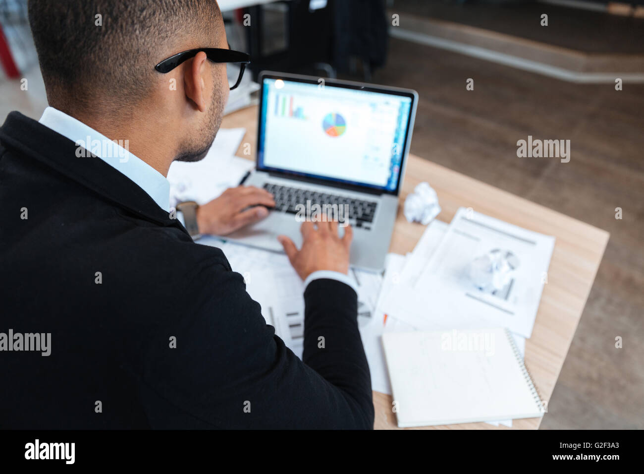 Back view of businessman typing on laptop in the office Stock Photo - Alamy