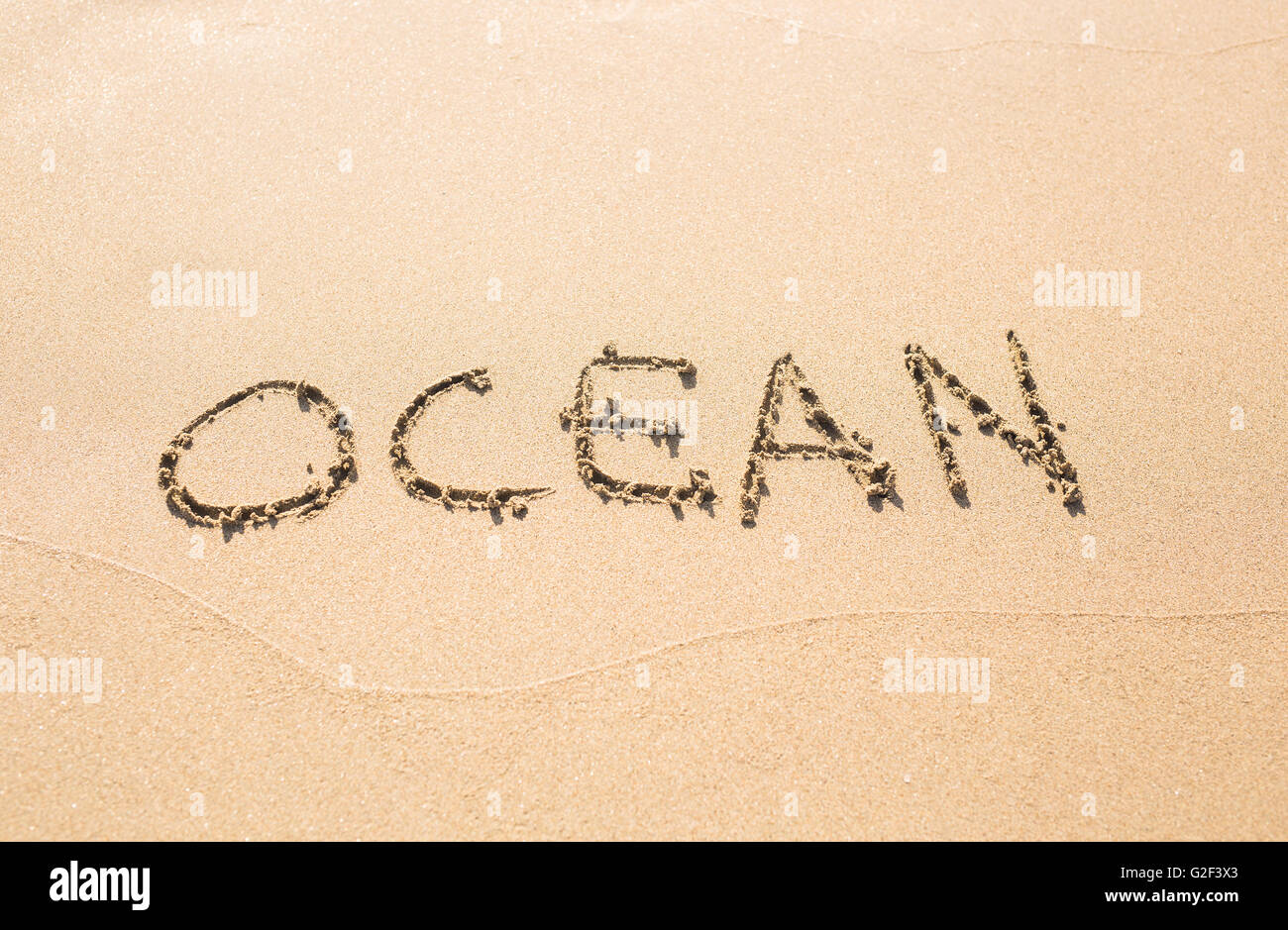 word OCEAN on the sand Stock Photo - Alamy