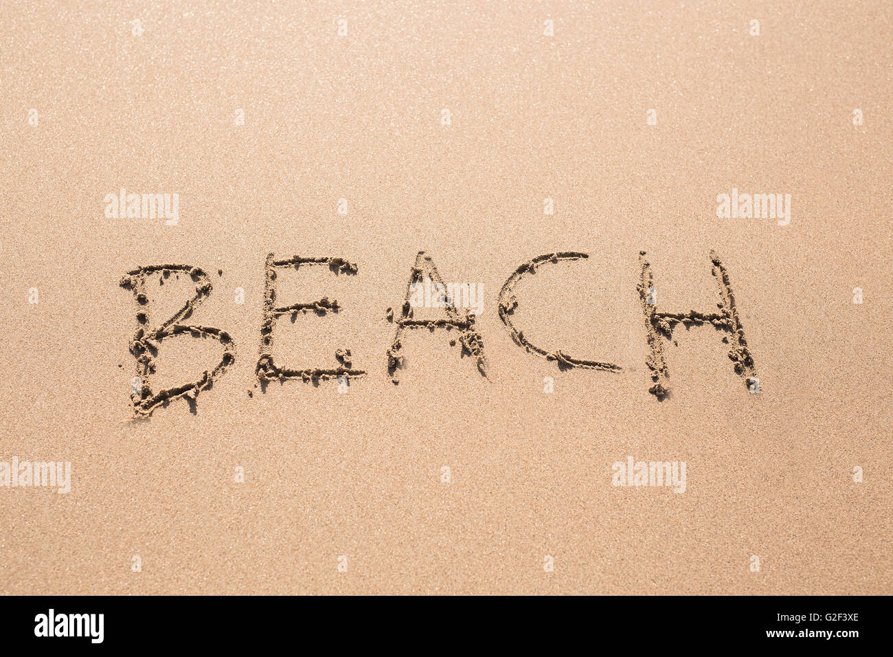 word Beach written on the sand Stock Photo - Alamy