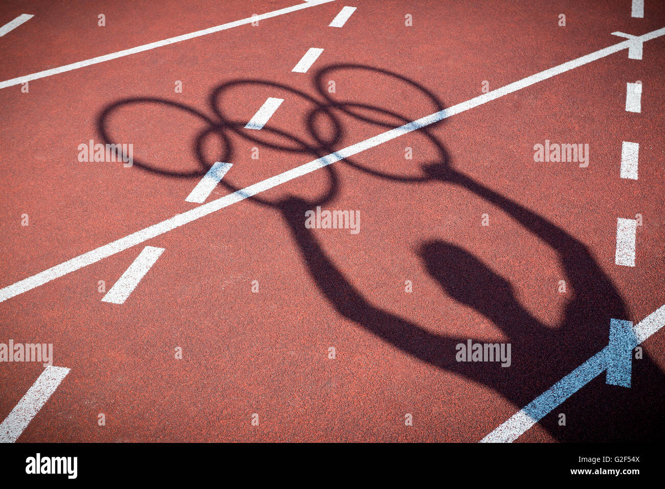 RIO DE JANEIRO - FEBRUARY 12, 2015: Shadow of an athlete holds Olympic ...