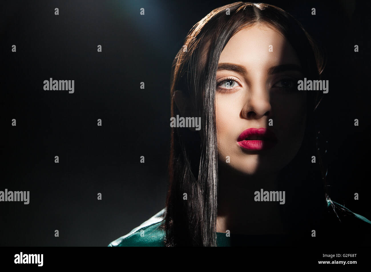 Close-up of black-haired woman with half face in shadow Stock Photo - Alamy