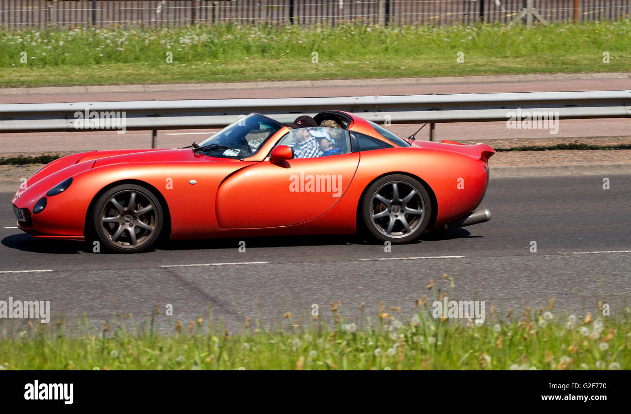 An orange luxurious TVR convertible super-car travelling along the ...