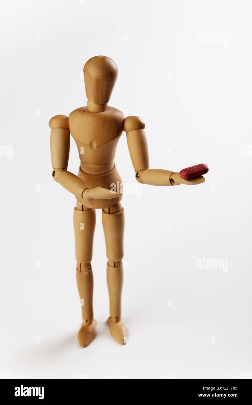 Sick puppet with stomach cramps and pile of colorful pills Stock Photo ...