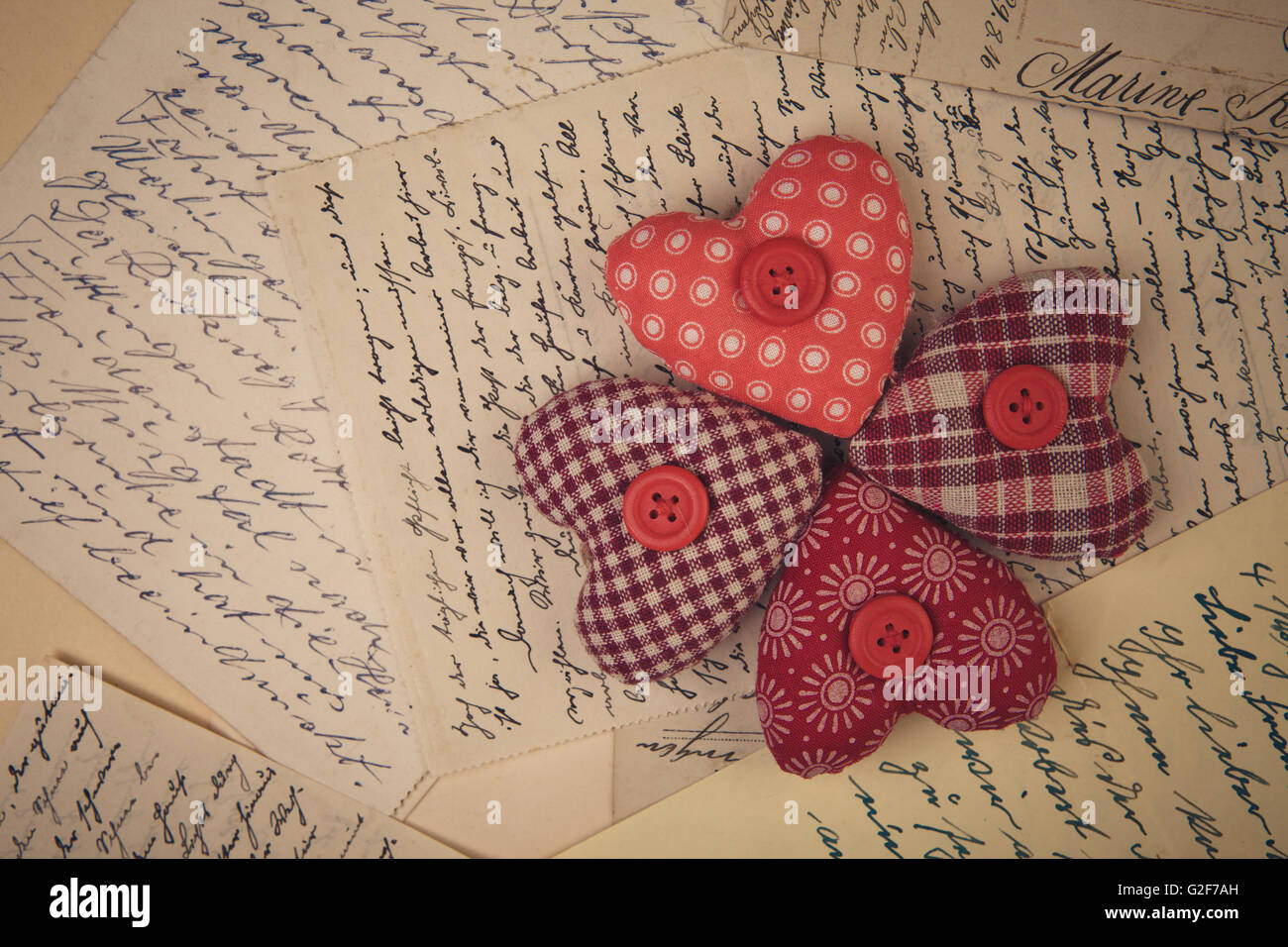 Cloth Hearts on handwritten old Vintage Letters Stock Photo - Alamy