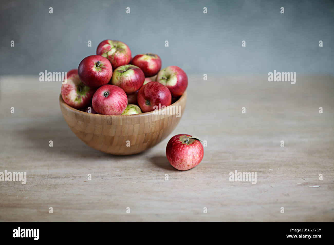 Ripe red Apples arranged on table in wooden bowl Stock Photo - Alamy