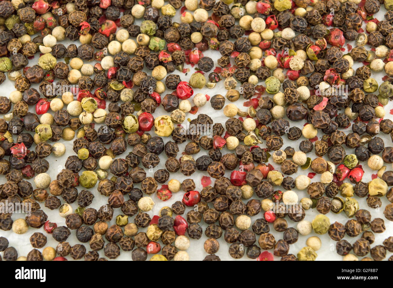 red and brown pepper balls on the white table Stock Photo - Alamy