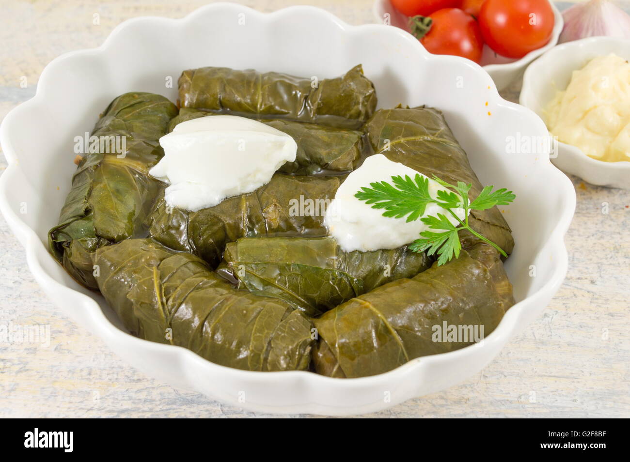 Sarma rolls in a plate covered with spices and sour cream Stock Photo ...