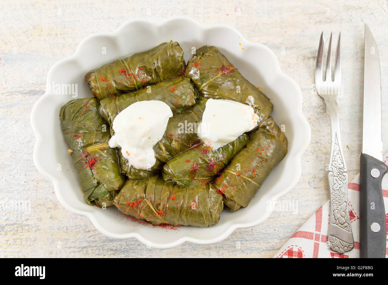 Sarma rolls in a plate covered with spices and sour cream Stock Photo ...