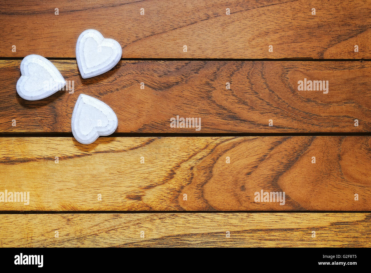 hearts forming a clover with wood background Stock Photo - Alamy