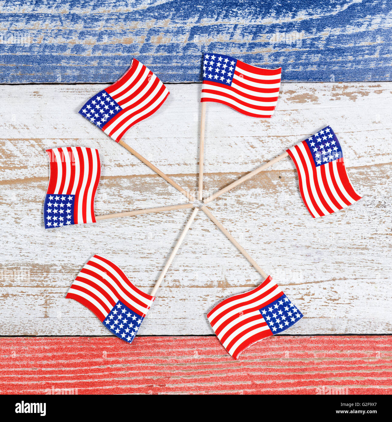 Small USA flags forming pinwheel formation on red, white and blue ...