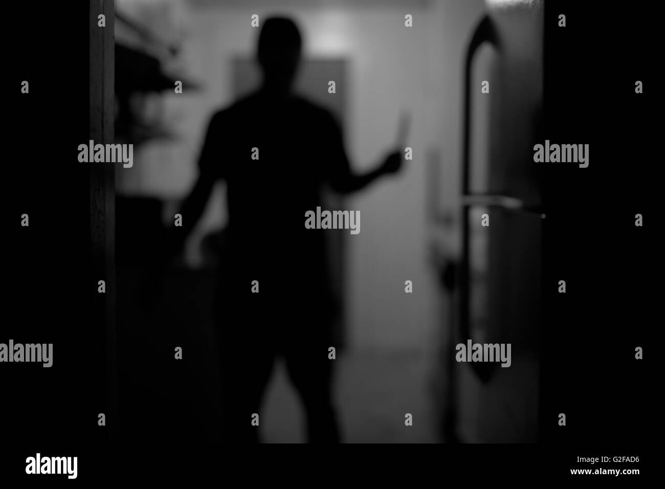 Man Holding Knife in Kitchen, Rear View, Silhouette Stock Photo - Alamy