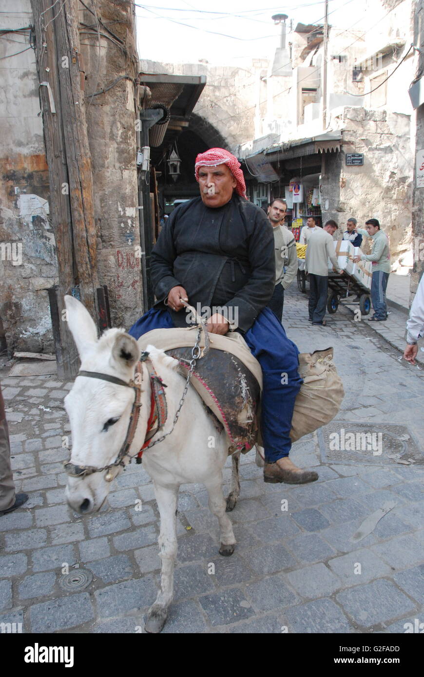 Aleppo - The Souqs, Man With Keffiyeh Riding Mule Stock Photo - Alamy