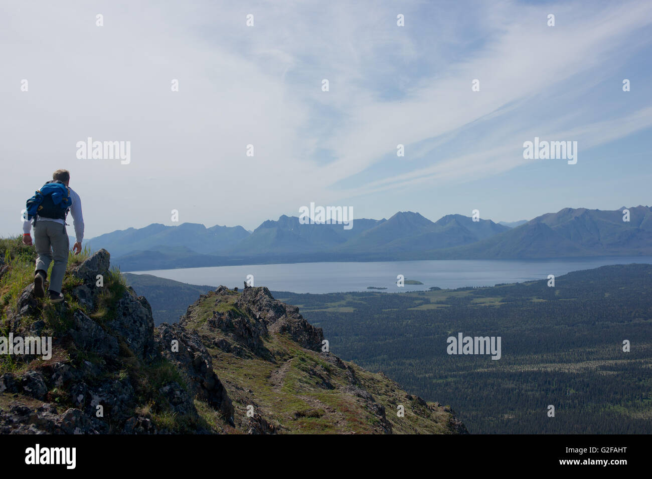 Young Man Hiking Along Rocky Ledge, Alaska, USA Stock Photo - Alamy
