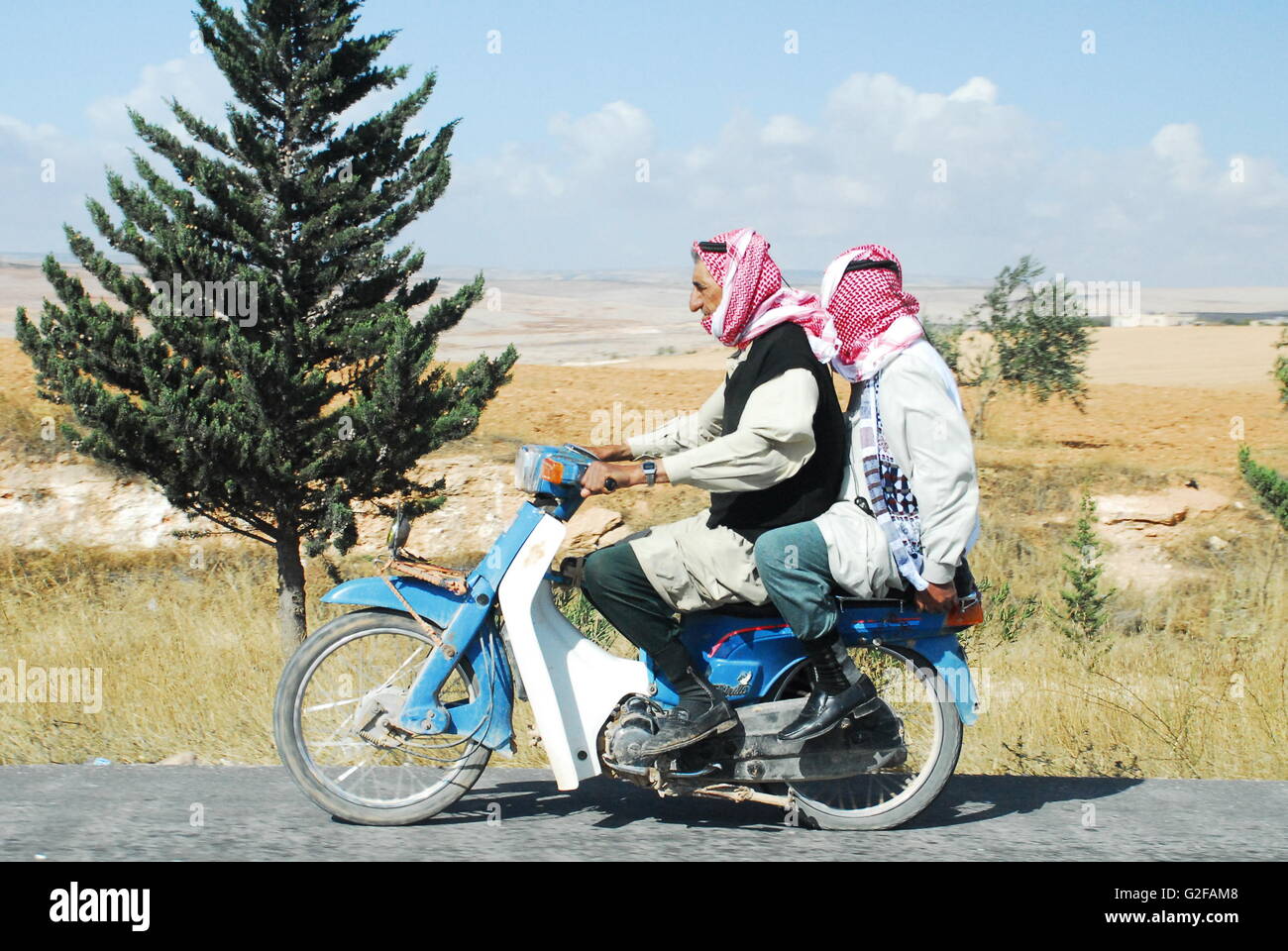 Two Men With Keffiyeh Riding A Motorcycle Stock Photo - Alamy
