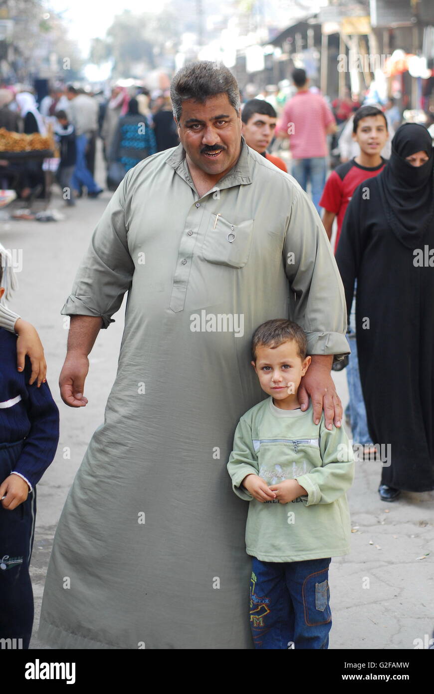 Al-Ma'ara - Fat Man With Son Stock Photo - Alamy