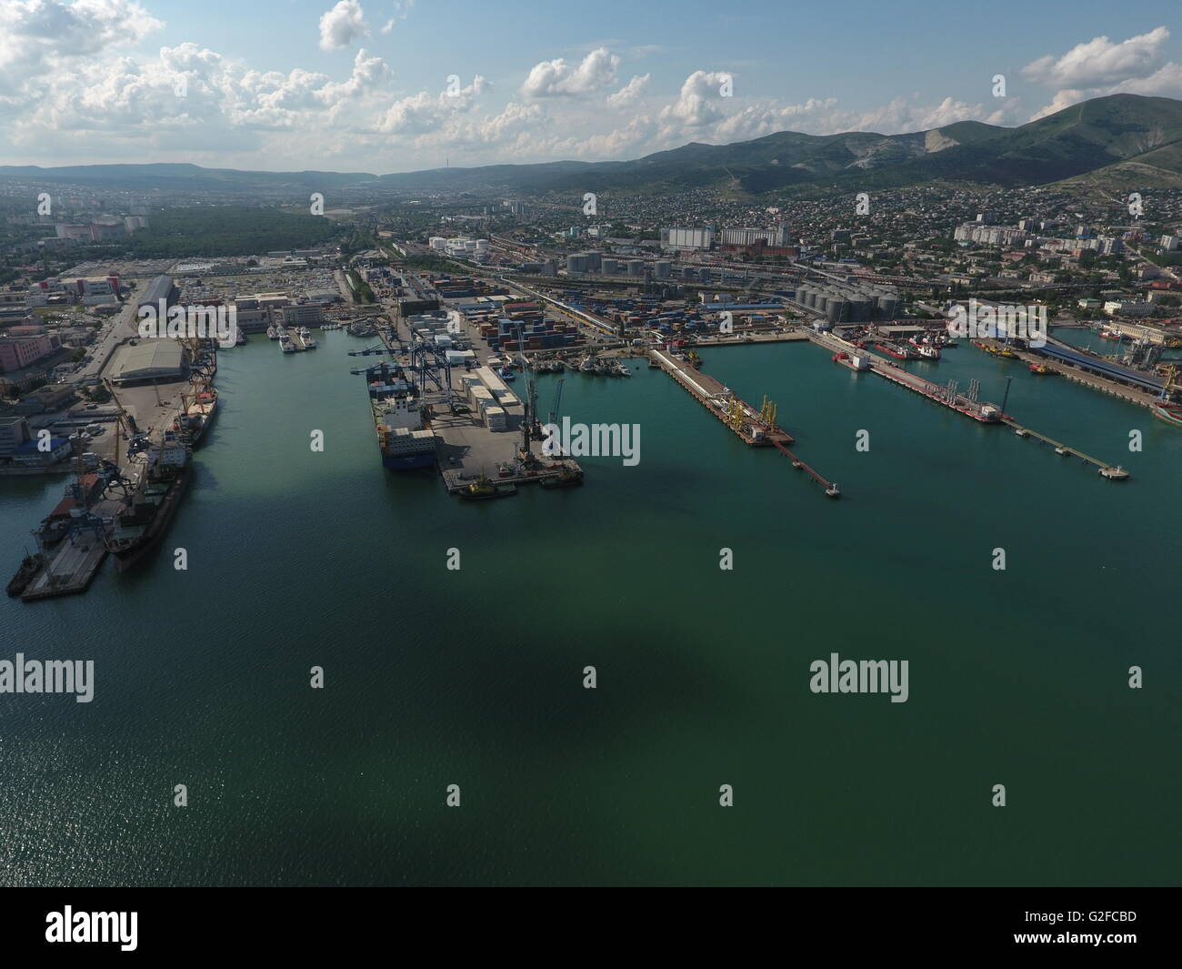 Industrial seaport, top view. Port cranes and cargo ships and barges ...
