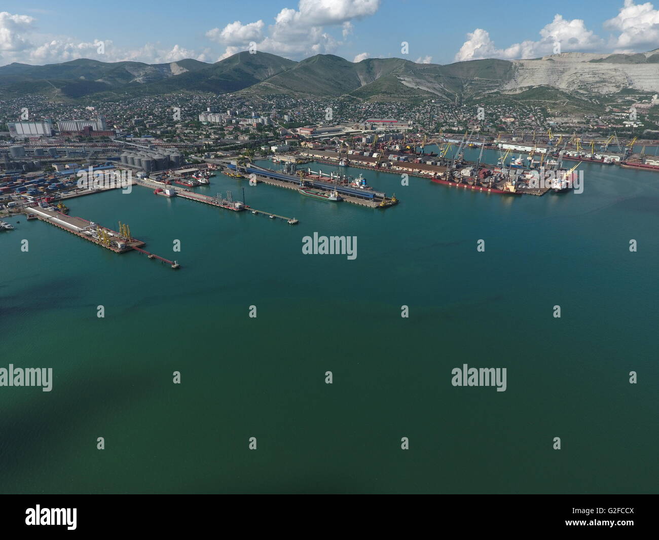 Industrial seaport, top view. Port cranes and cargo ships and barges ...