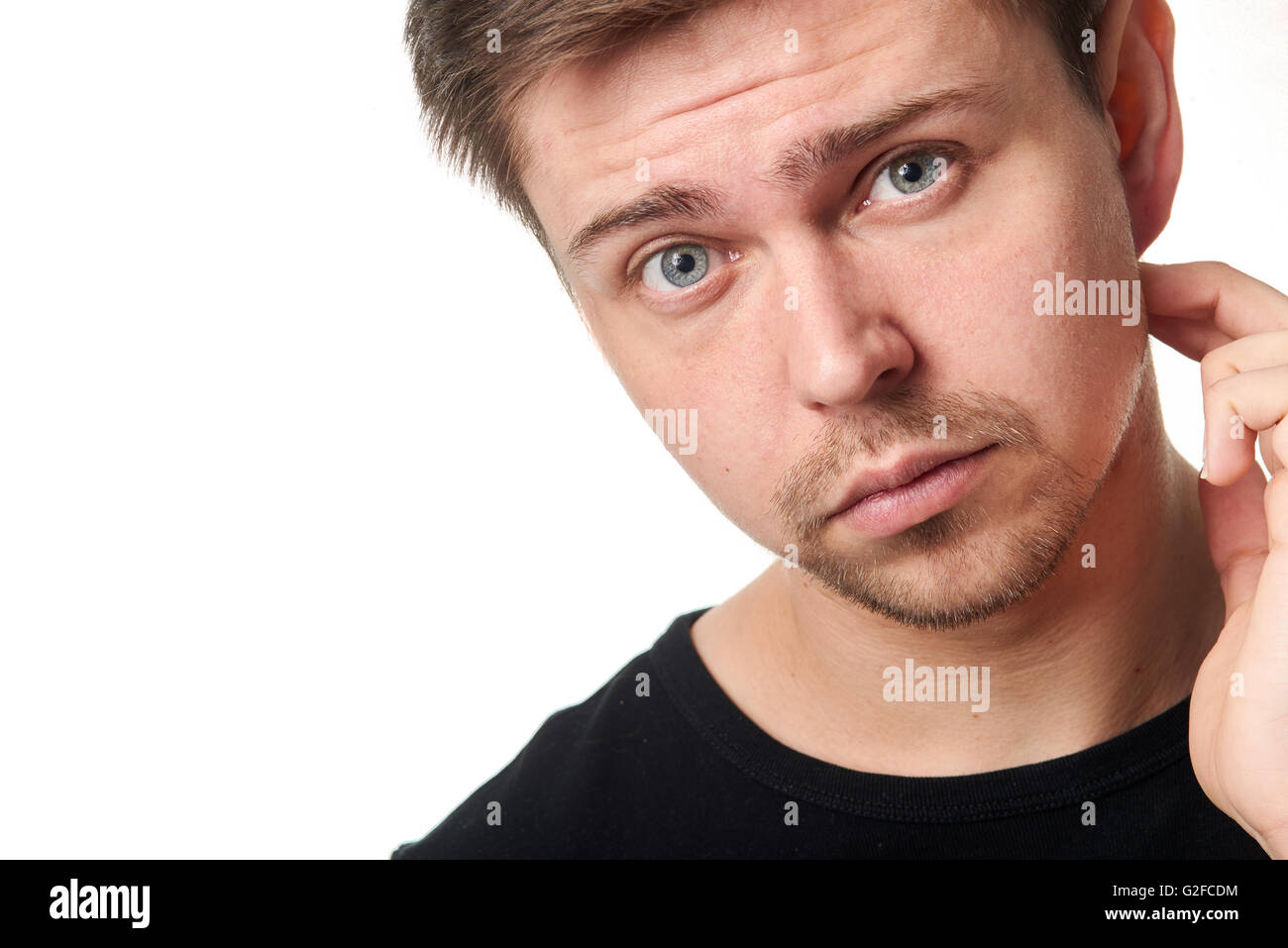 Portrait of serious young man, questioning expression,horizontal on ...