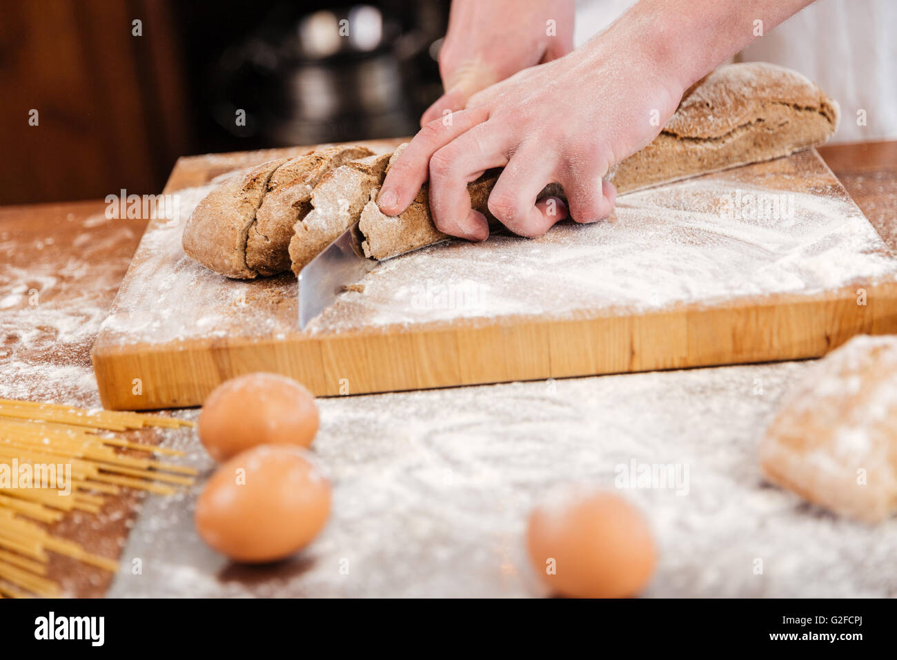 Man bread kitchen cutting hi-res stock photography and images - Alamy