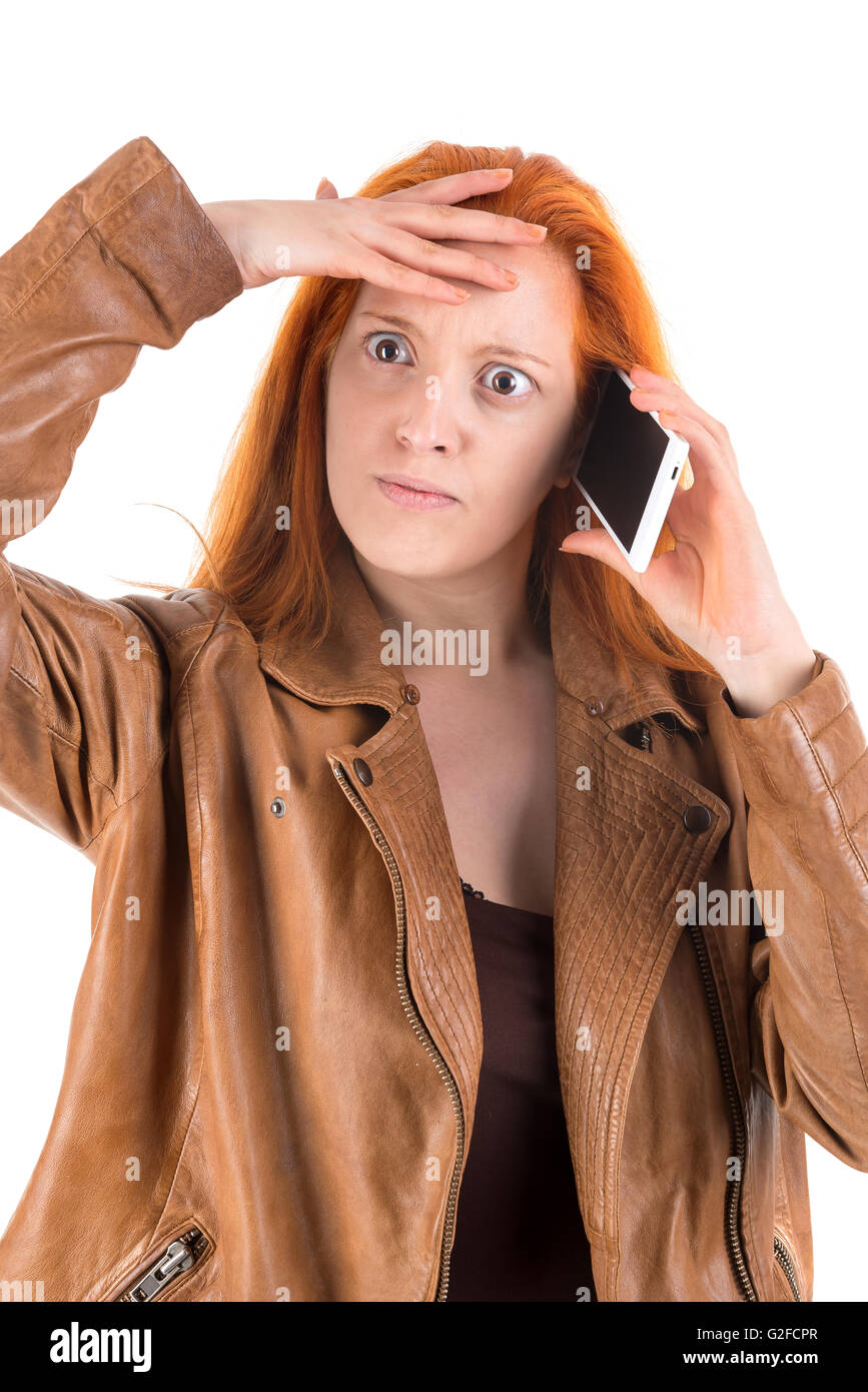 Stressed red hair girl with cellphone isolated in white Stock Photo - Alamy