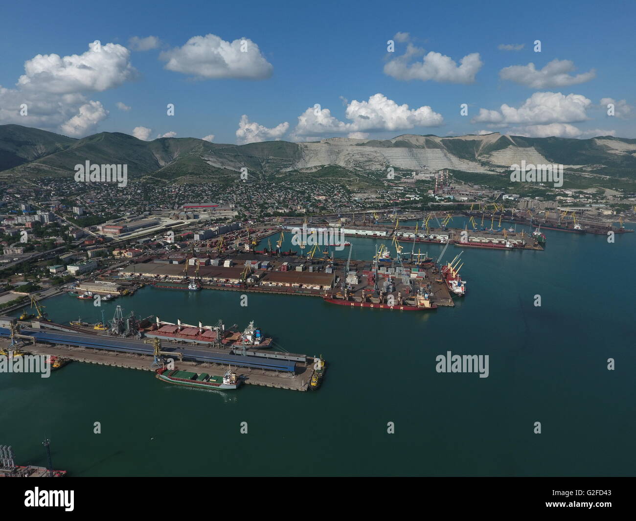 Industrial seaport, top view. Port cranes and cargo ships and barges ...