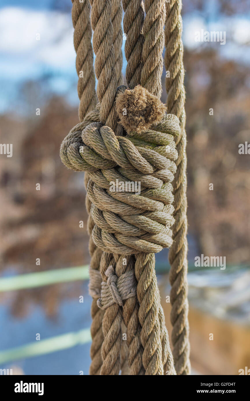 Close-up of vintage marine ropes with nautical knot on old sailing ...