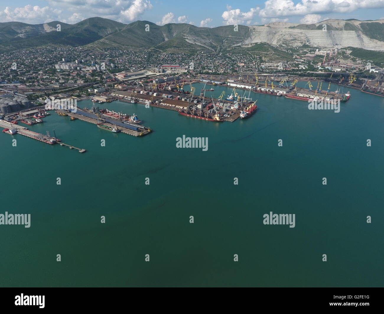 Industrial seaport, top view. Port cranes and cargo ships and barges ...